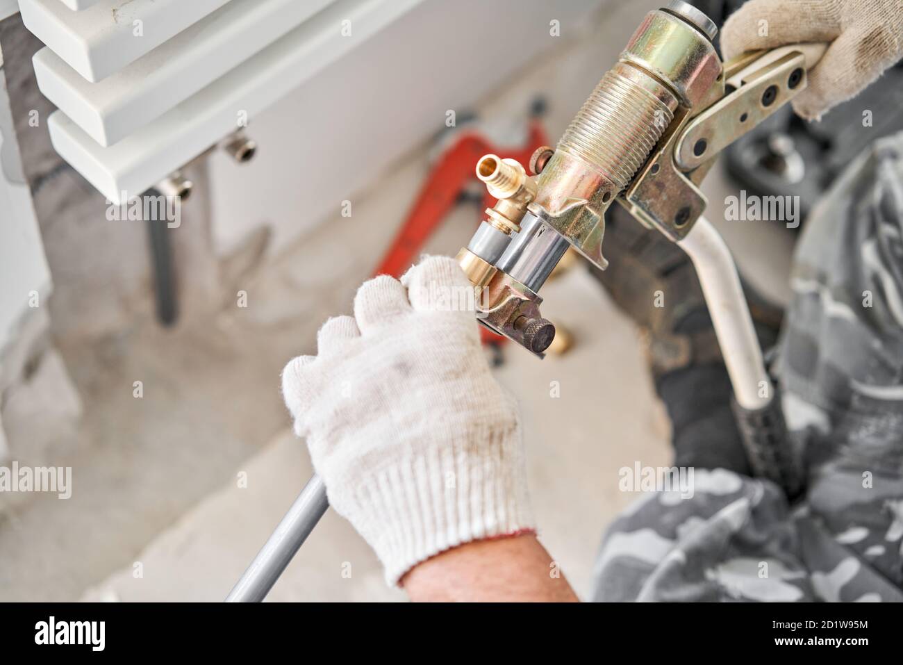 connection heating pipes to white Radiator in a new apartment under ...