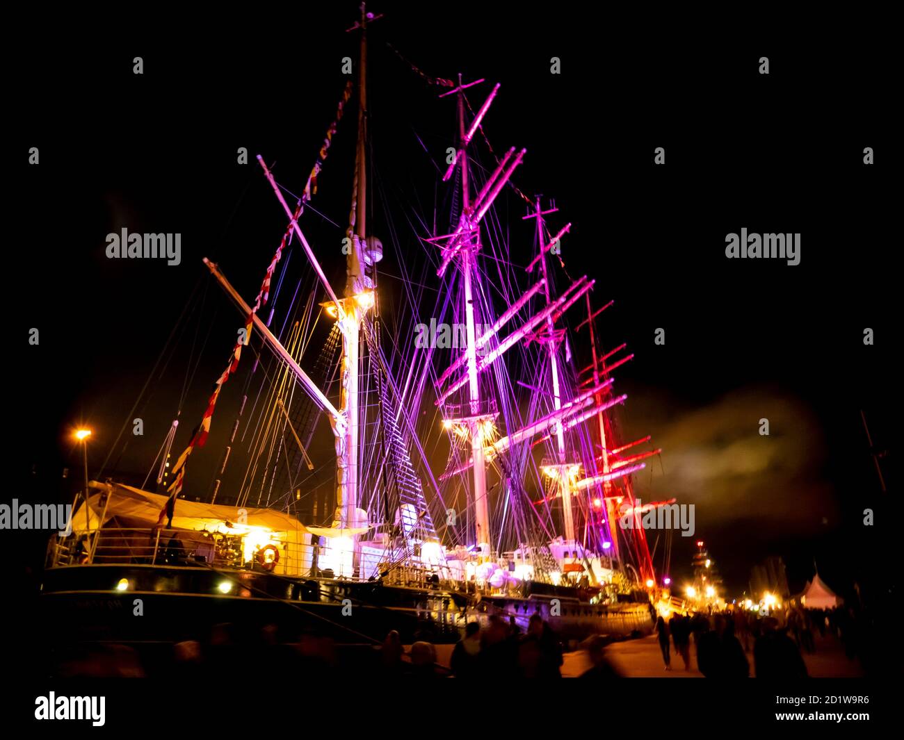 Colorful lights on masts on sailboats surrounding blurred by motion ...