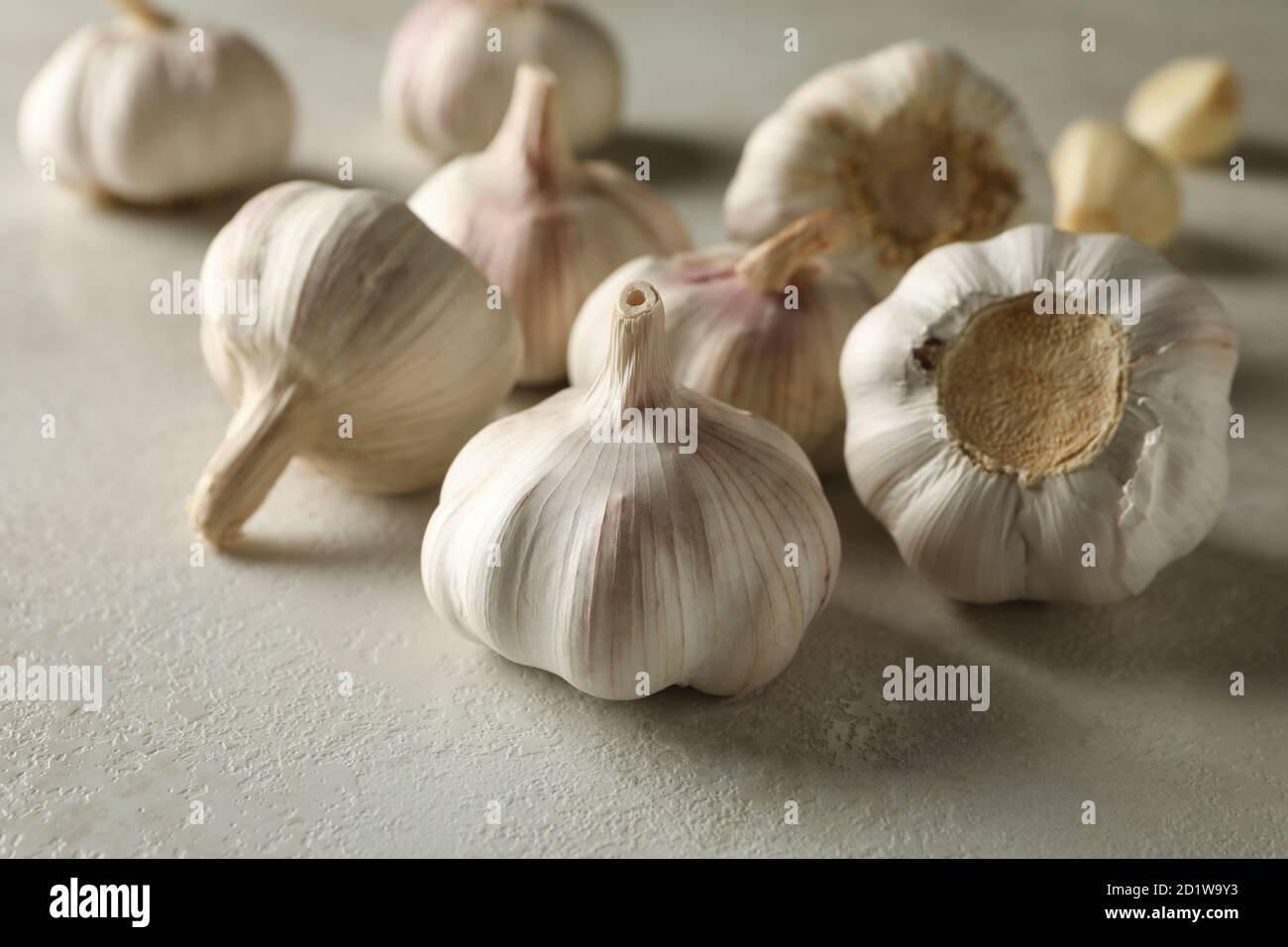 Raw garlic on light background, close up Stock Photo - Alamy