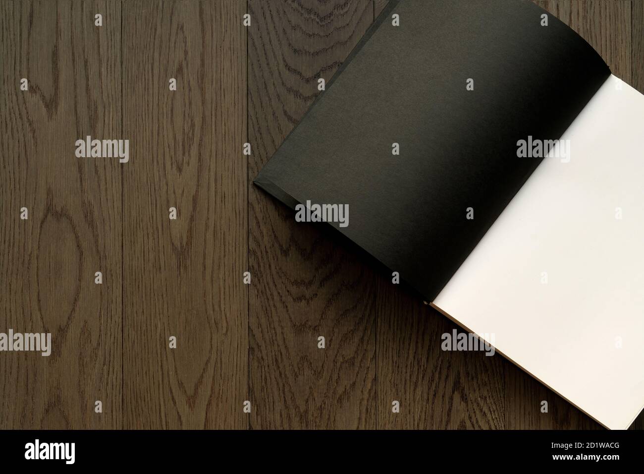 Open book on wooden table with black and white empty pages. Booklet ...