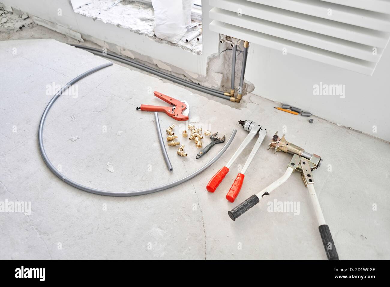 Tools for Work As A Plumber. Connection heating pipes to white Radiator ...