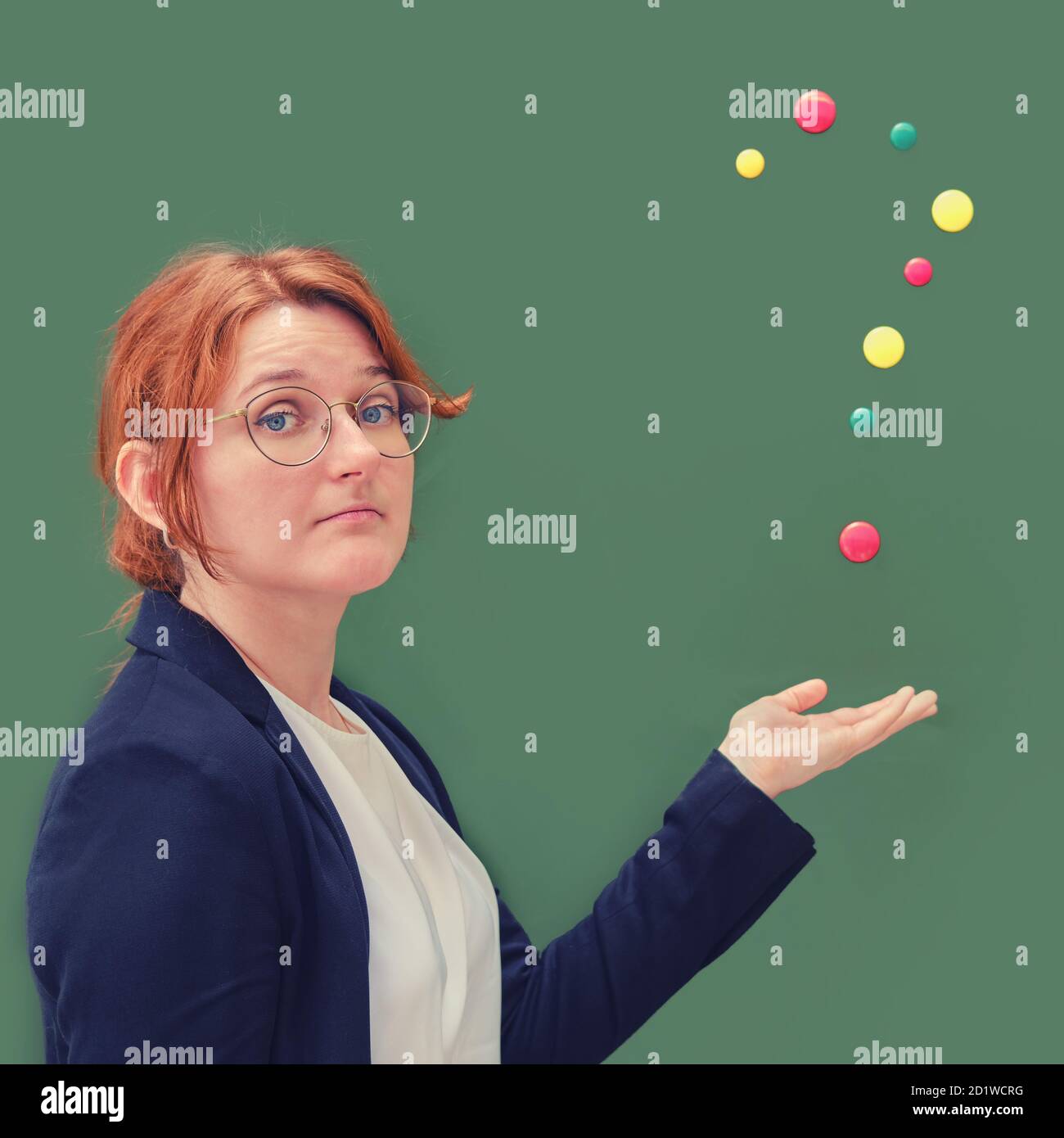 Female teacher with a sad face and a question mark on a blackboard ...