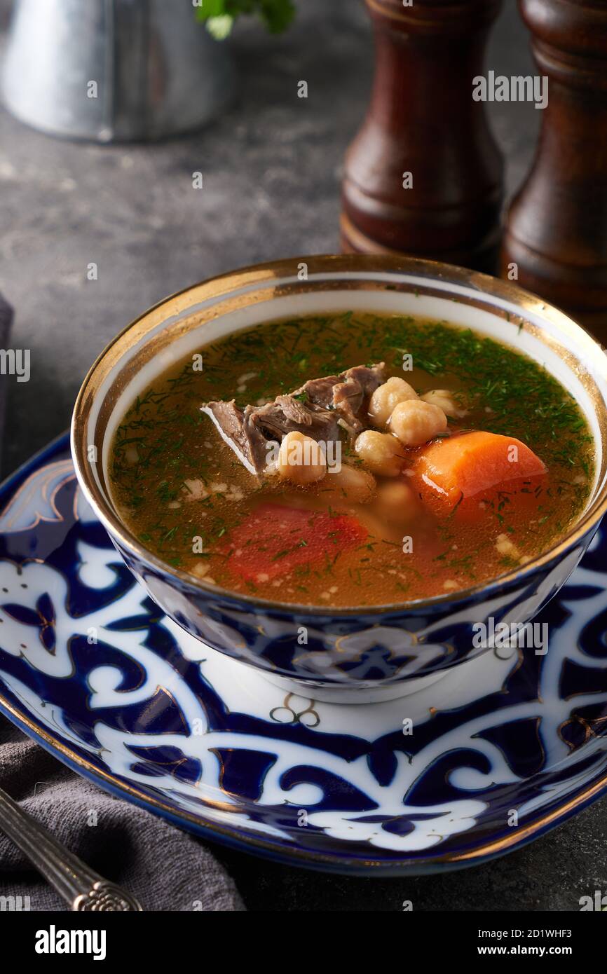 Traditional asian shurpa soup in traditional ornament bowl on ray ...