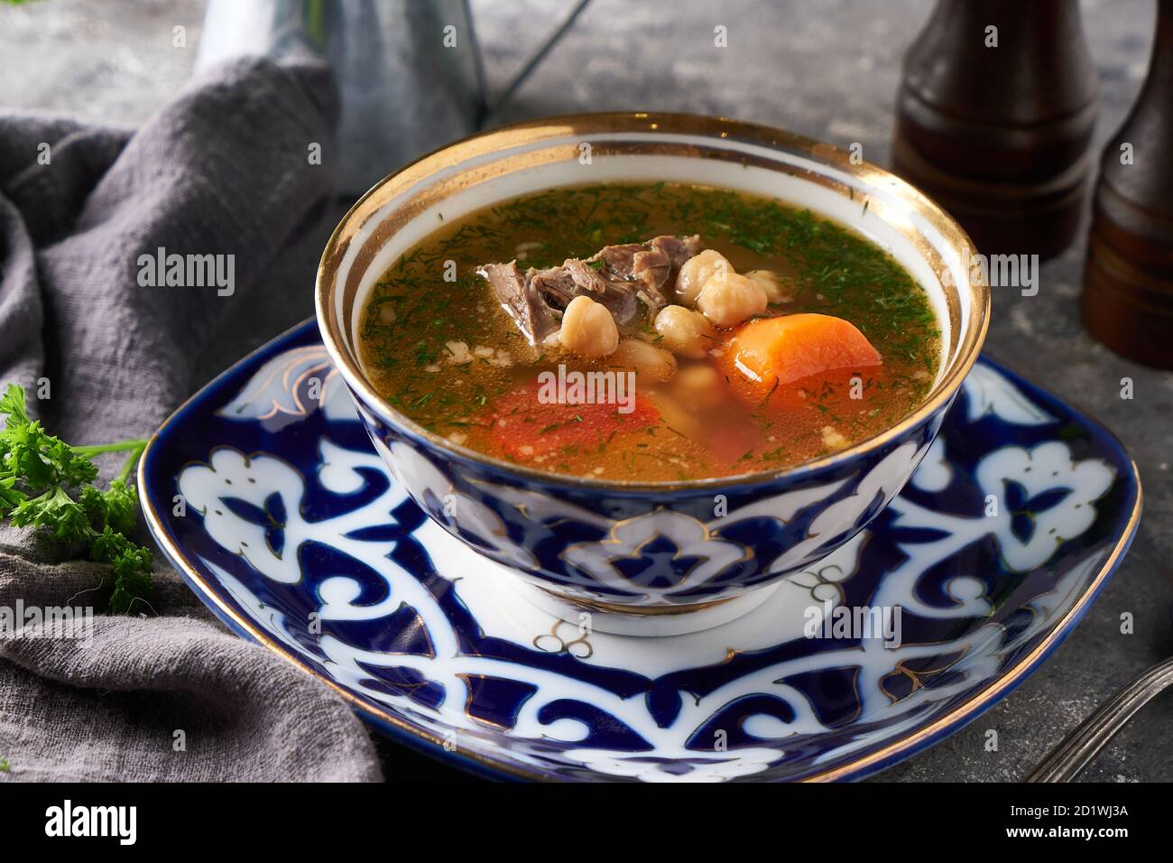 Traditional asian shurpa soup in traditional ornament bowl on ray ...