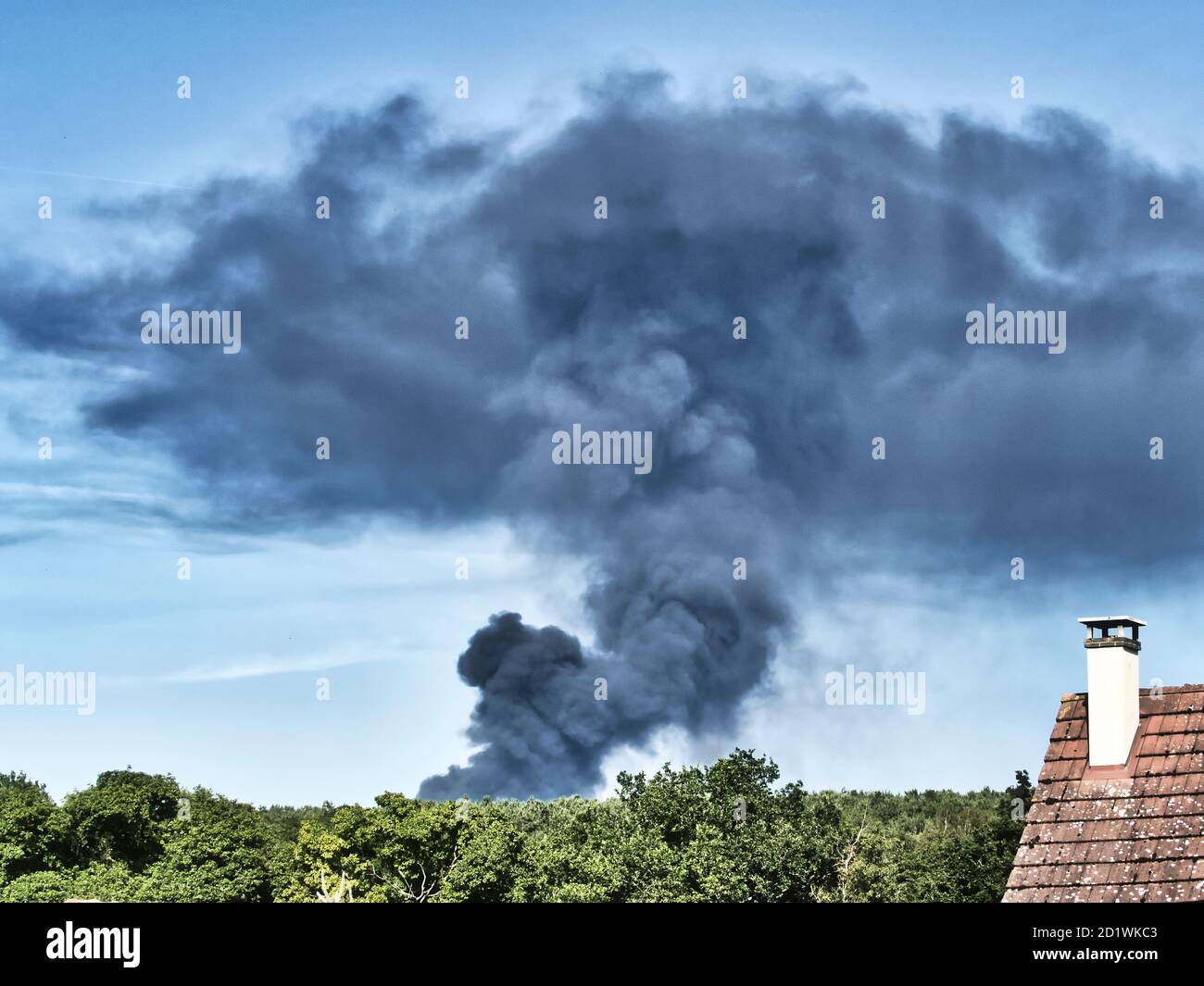 A Burning plastic recycling place causes a big pile of dark, black ...
