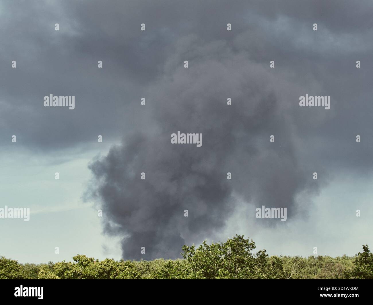 A Burning plastic recycling place causes a big pile of dark, black ...