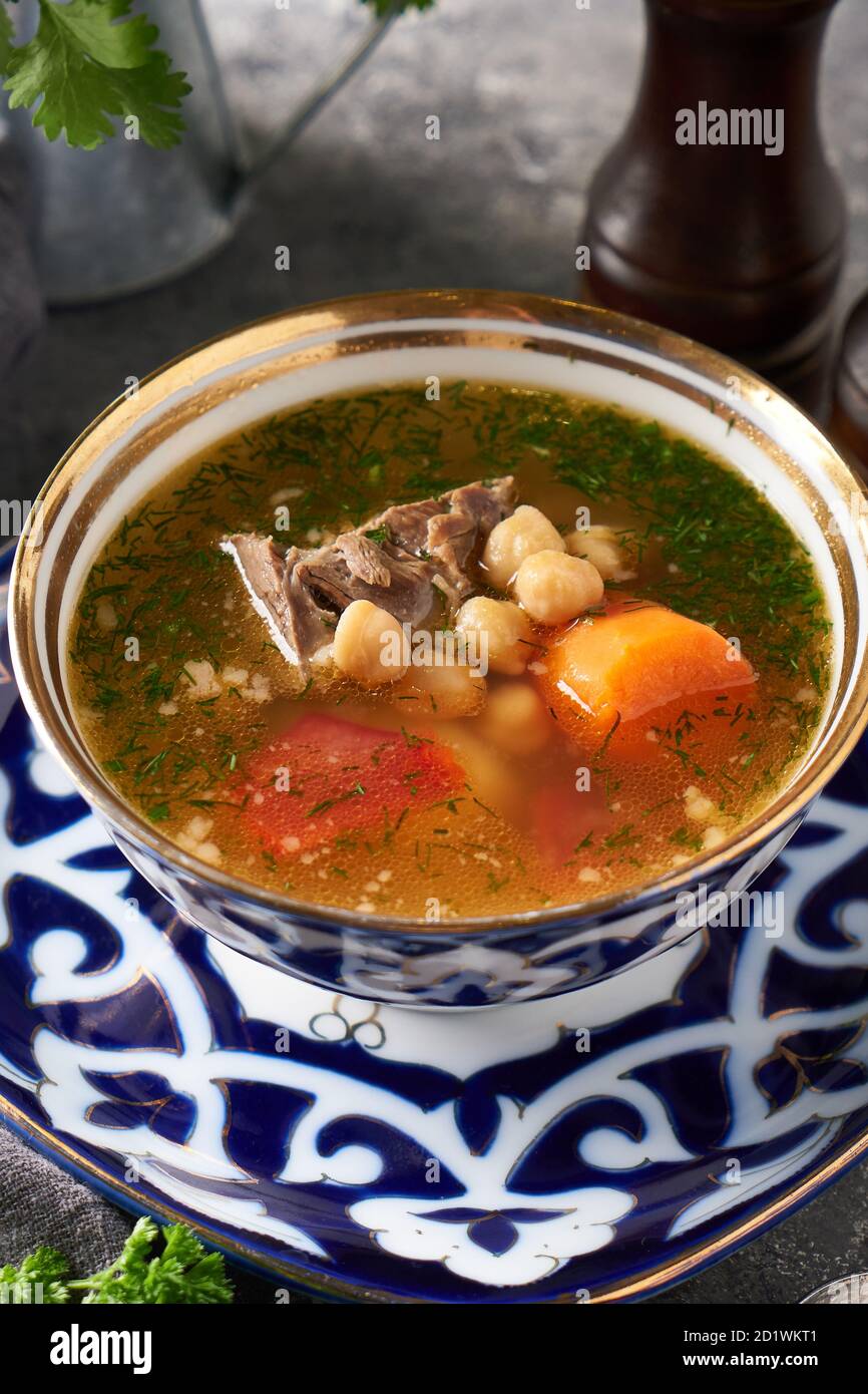 Traditional asian shurpa soup in traditional ornament bowl on ray ...