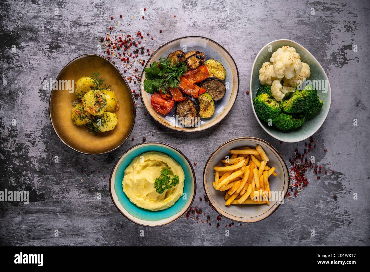 different side dishes on a grey background, French fries, mashed ...