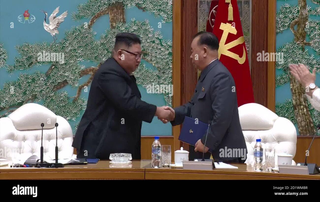 N.K.'s politburo meeting North Korean leader Kim Jong-un (L) shakes ...