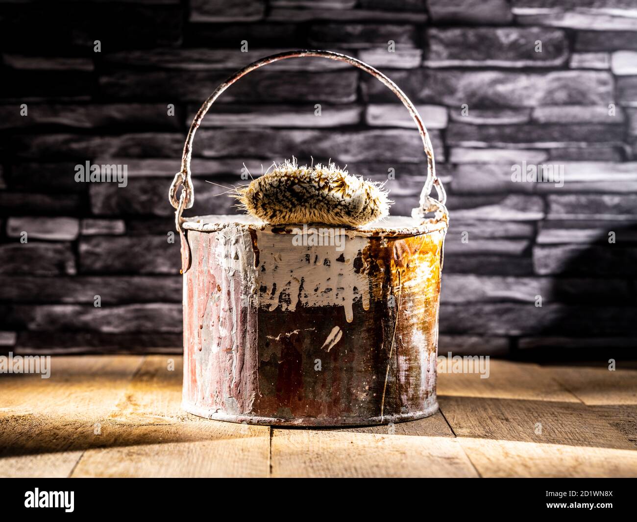 Paint tin bucket splattered with red and white paint with old paint ...