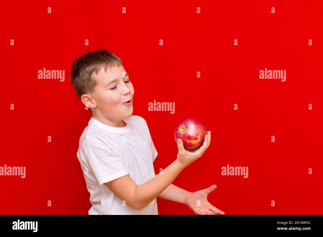 Side view Close up European boy kid child schoolboy throw up apple ...