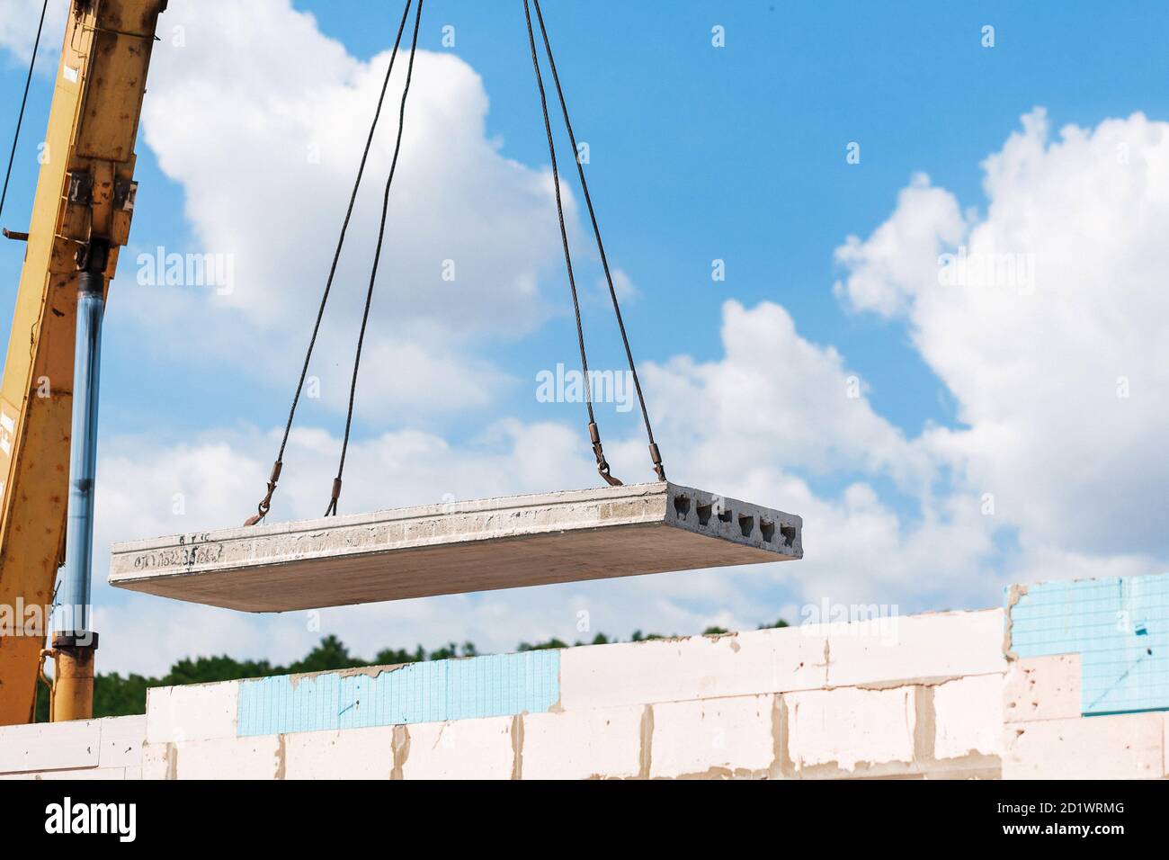 Builder worker installing concrete floor slab panel at building ...