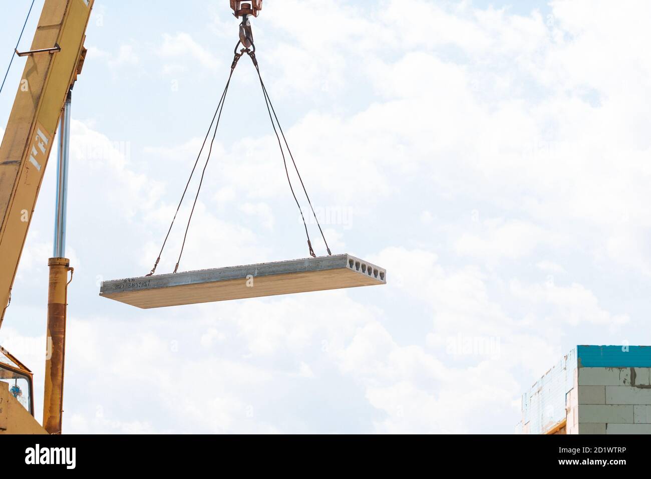 Builder worker installing concrete floor slab panel at building ...