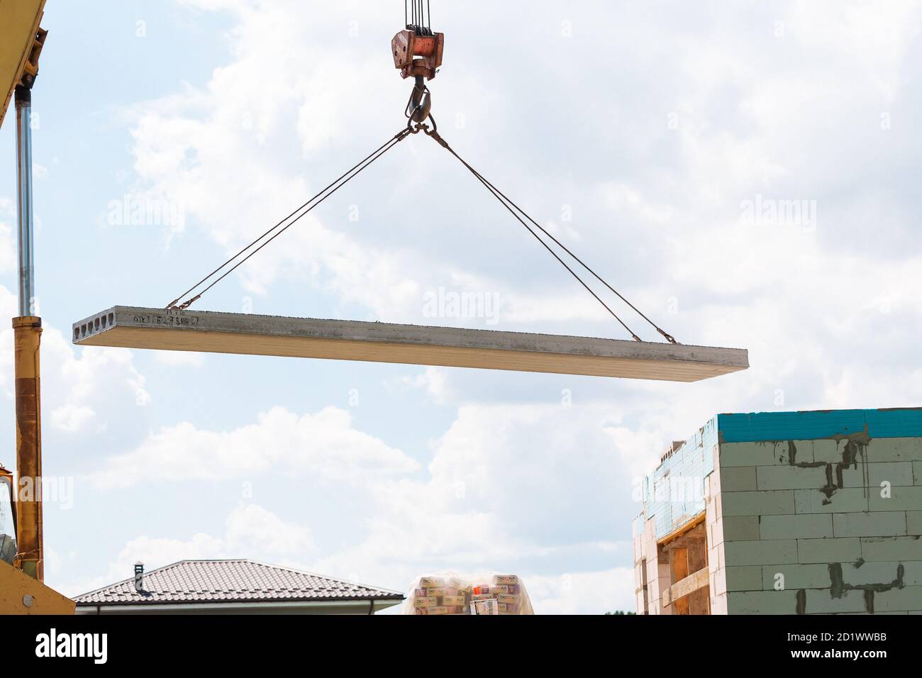 Builder worker installing concrete floor slab panel at building ...