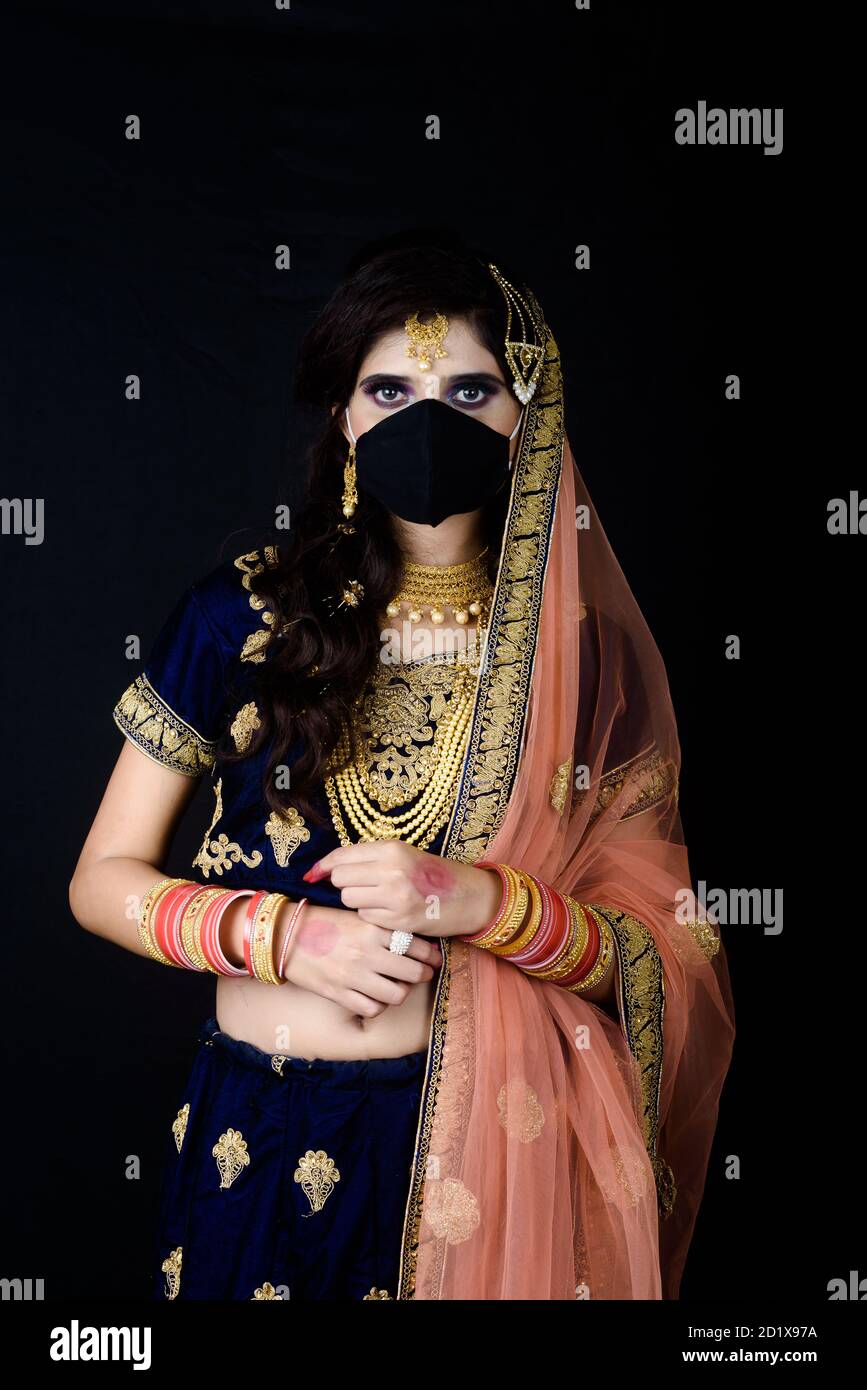 Bride wearing white Indian traditional cloth with face mask during ...