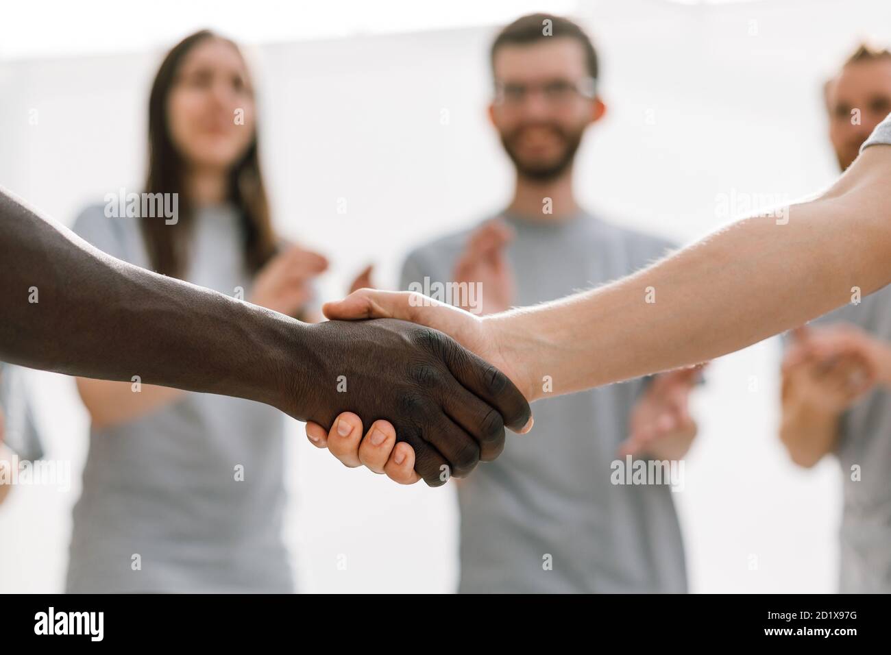 close up. strong handshake of two students of different nationalities ...