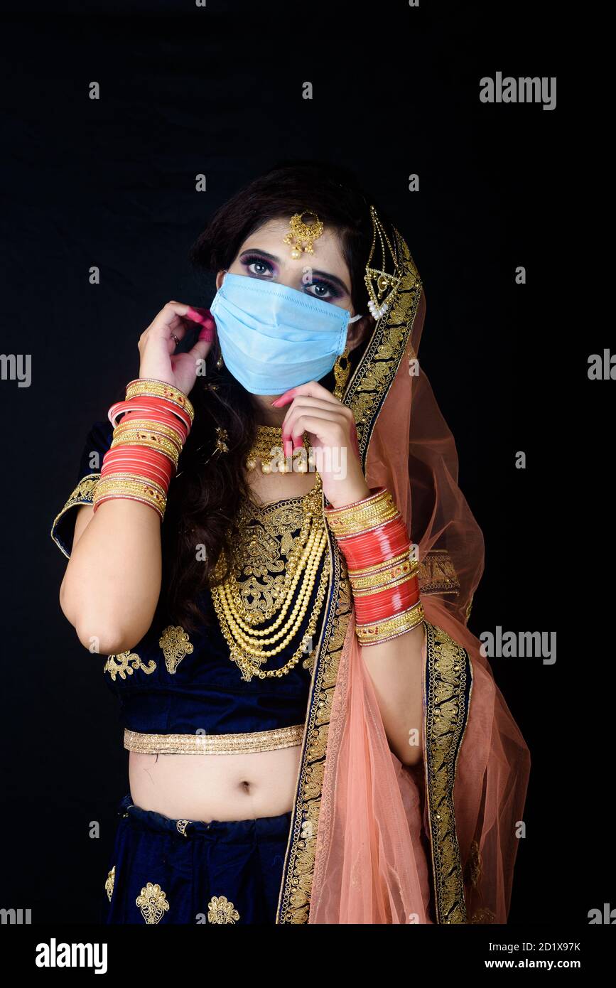 Bride wearing white Indian traditional cloth with face mask during ...