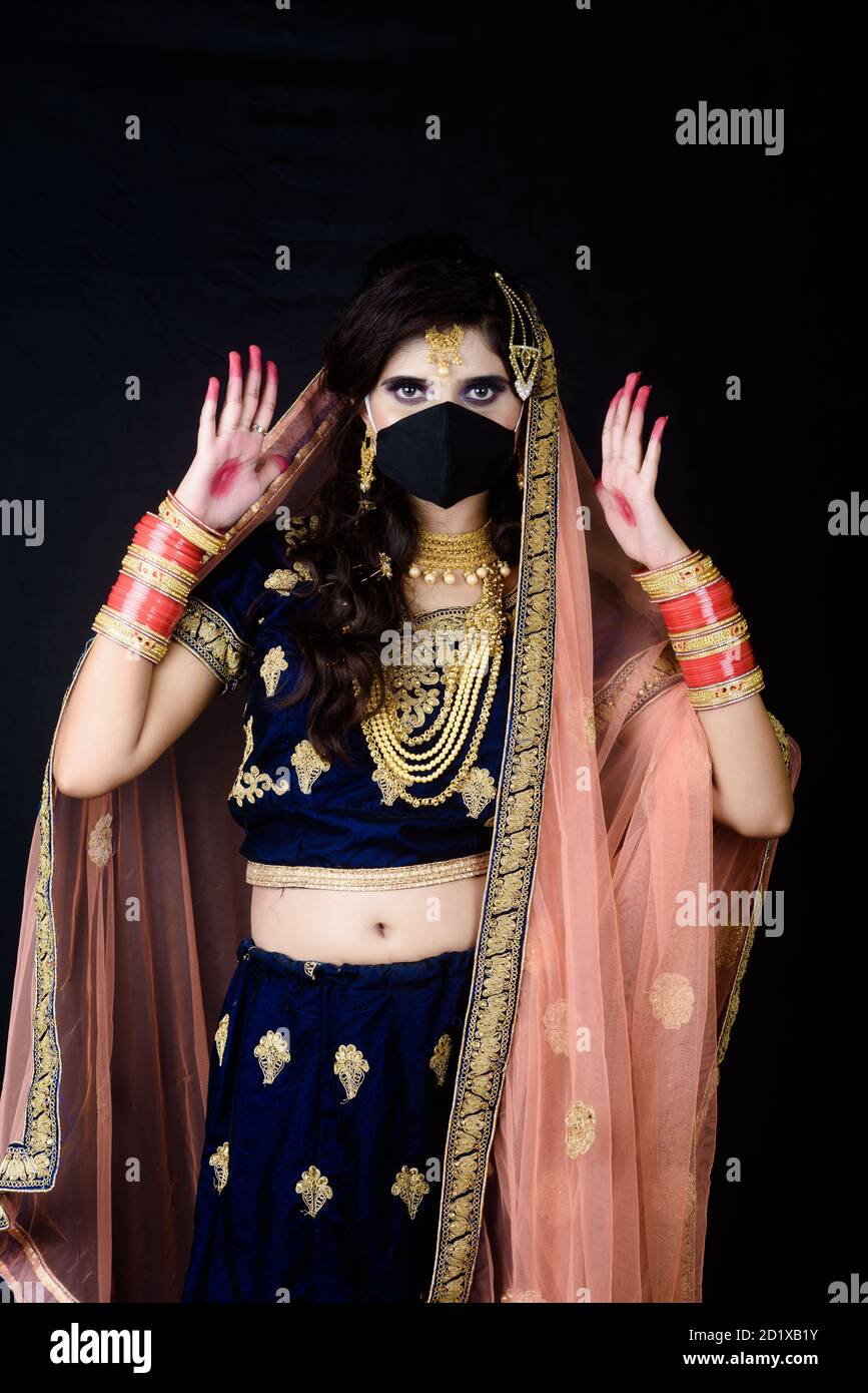 Bride wearing white Indian traditional cloth with face mask during ...