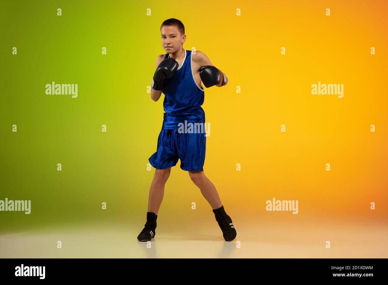 Fighter. Teenage professional boxer training in action, motion isolated ...