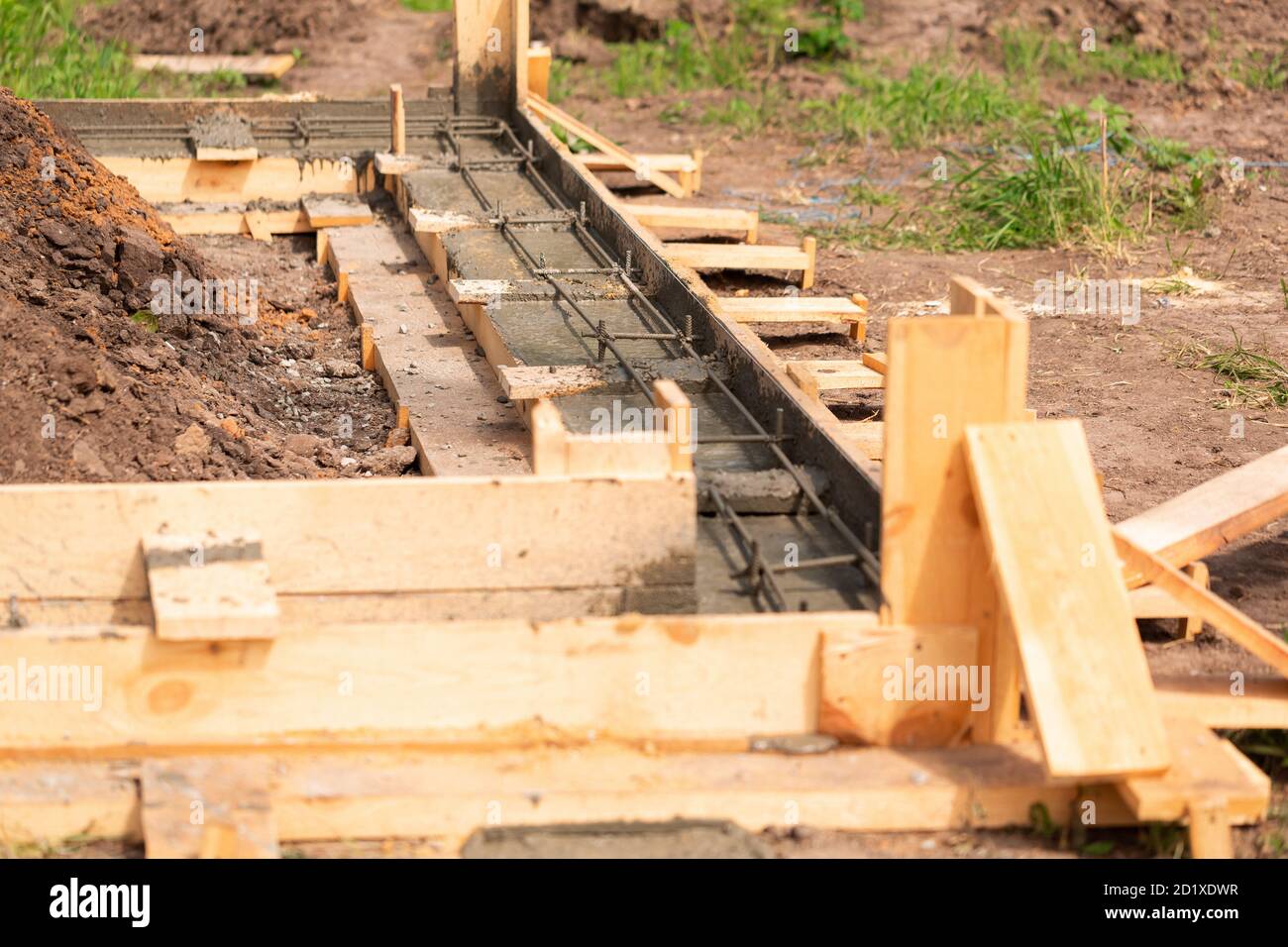 Lay of the cement or concrete into the foundation formwork with ...