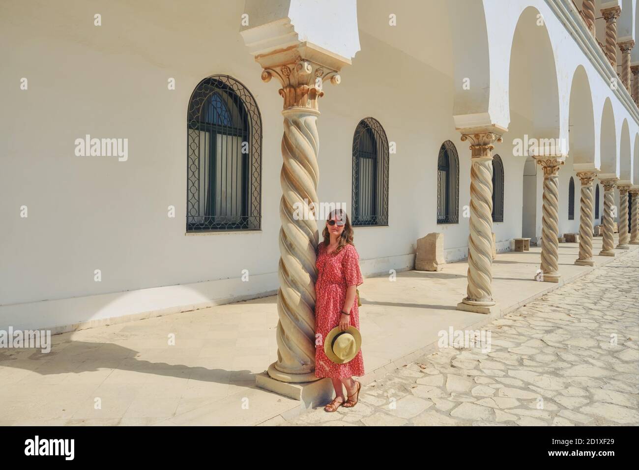 A woman stands next to the twisted spiral columns of a medieval French ...