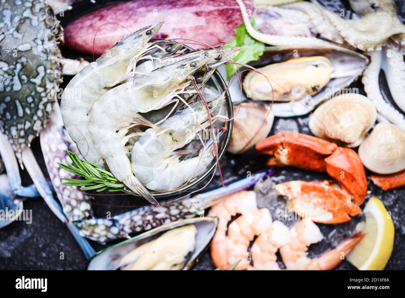 Seafood shellfish on ice frozen with shrimps prawns crab claws shell ...