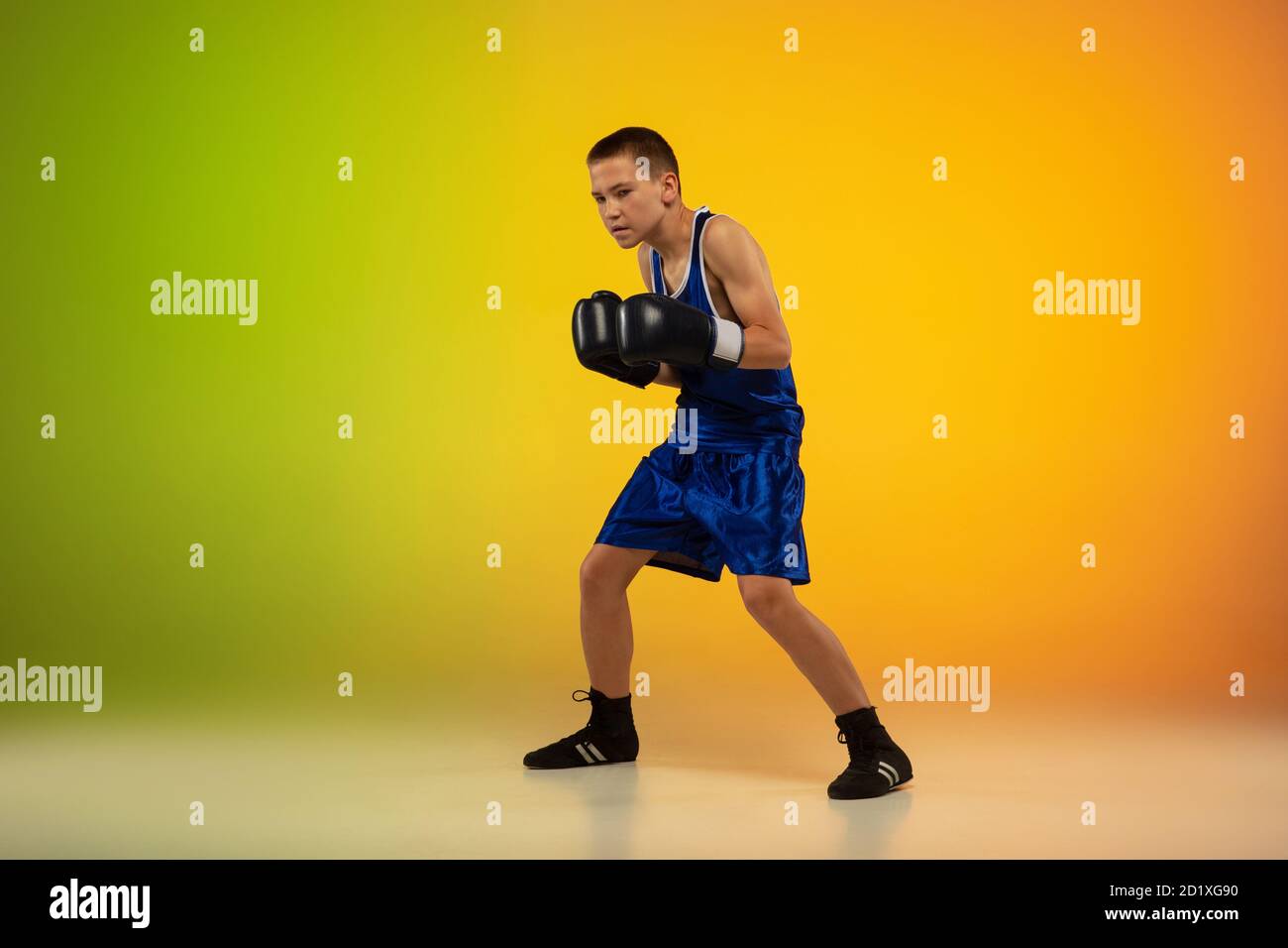 Winner. Teenage professional boxer training in action, motion isolated ...