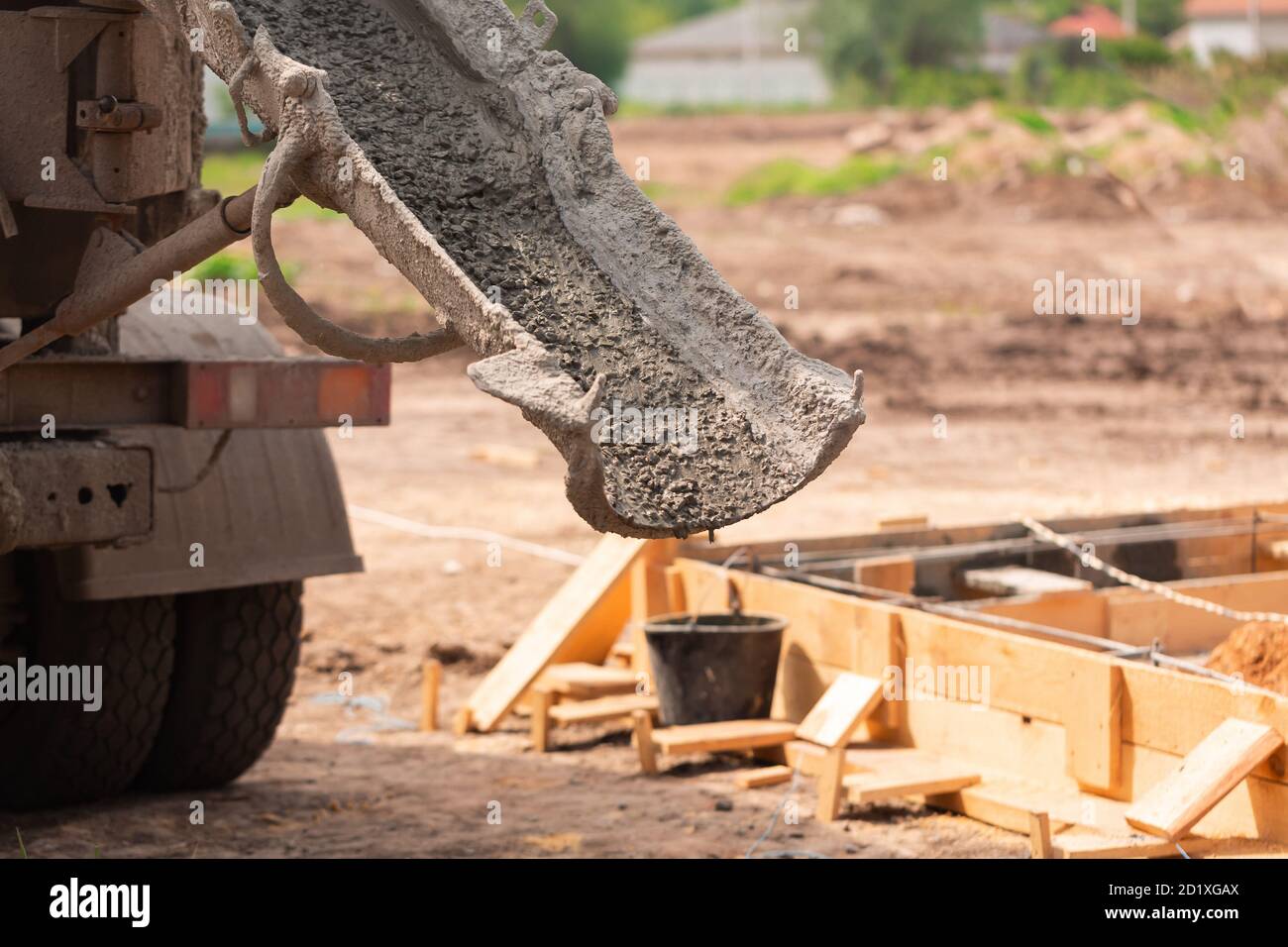 Lay of the cement or concrete into the foundation formwork with ...