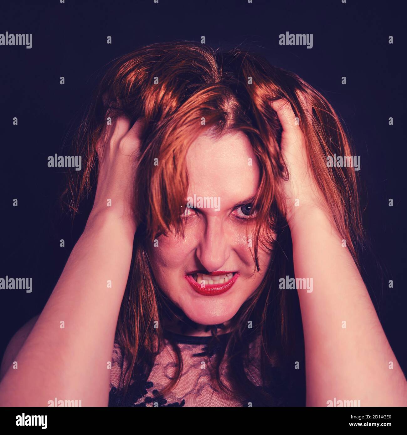 Face vampire woman with red hair on Halloween. Angry look of a vamp ...