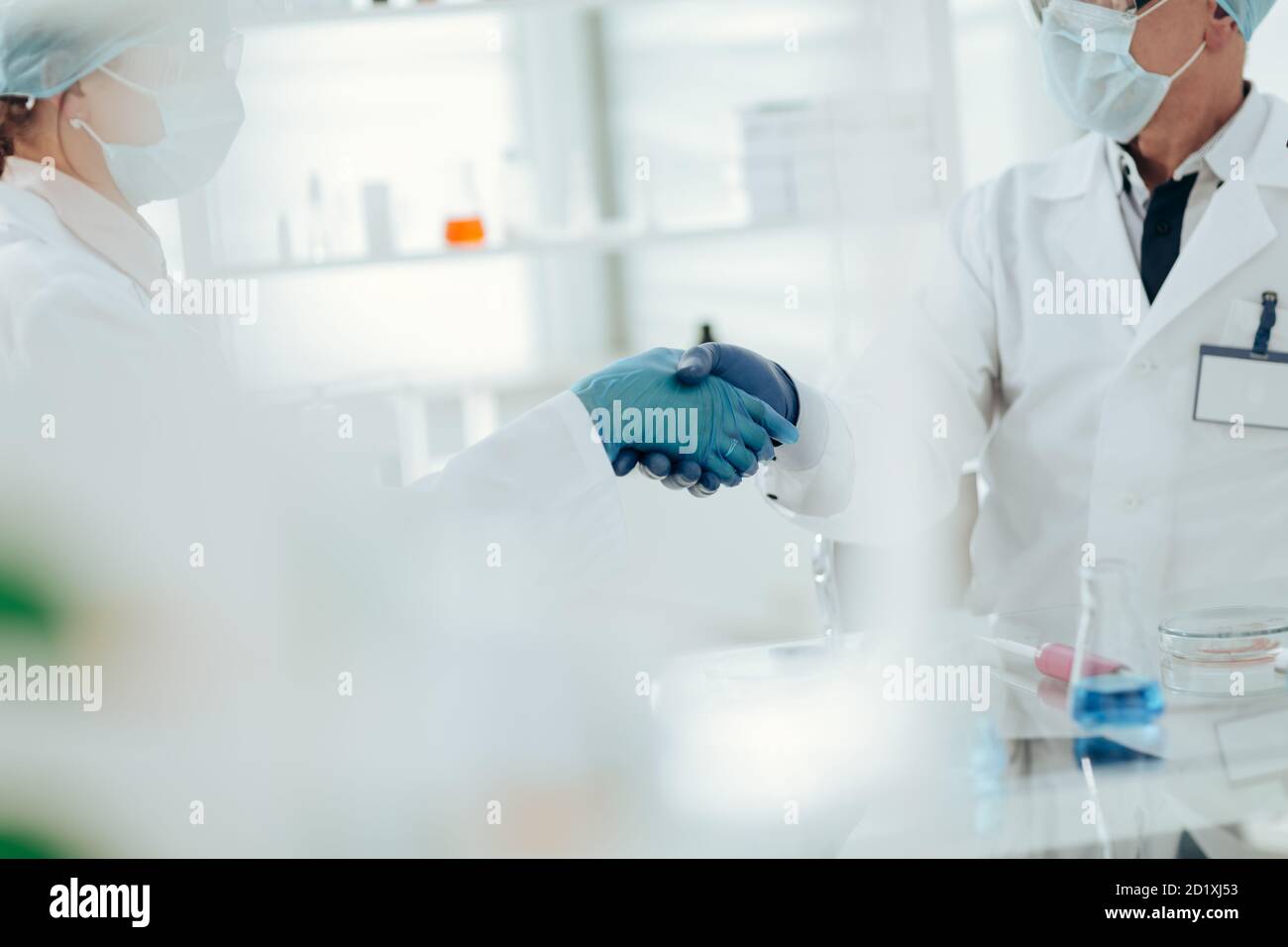 close up. scientists colleagues shaking hands with each other Stock ...