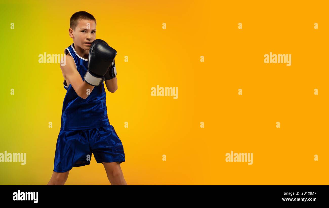Competitive. Teenage professional boxer training in action, motion ...