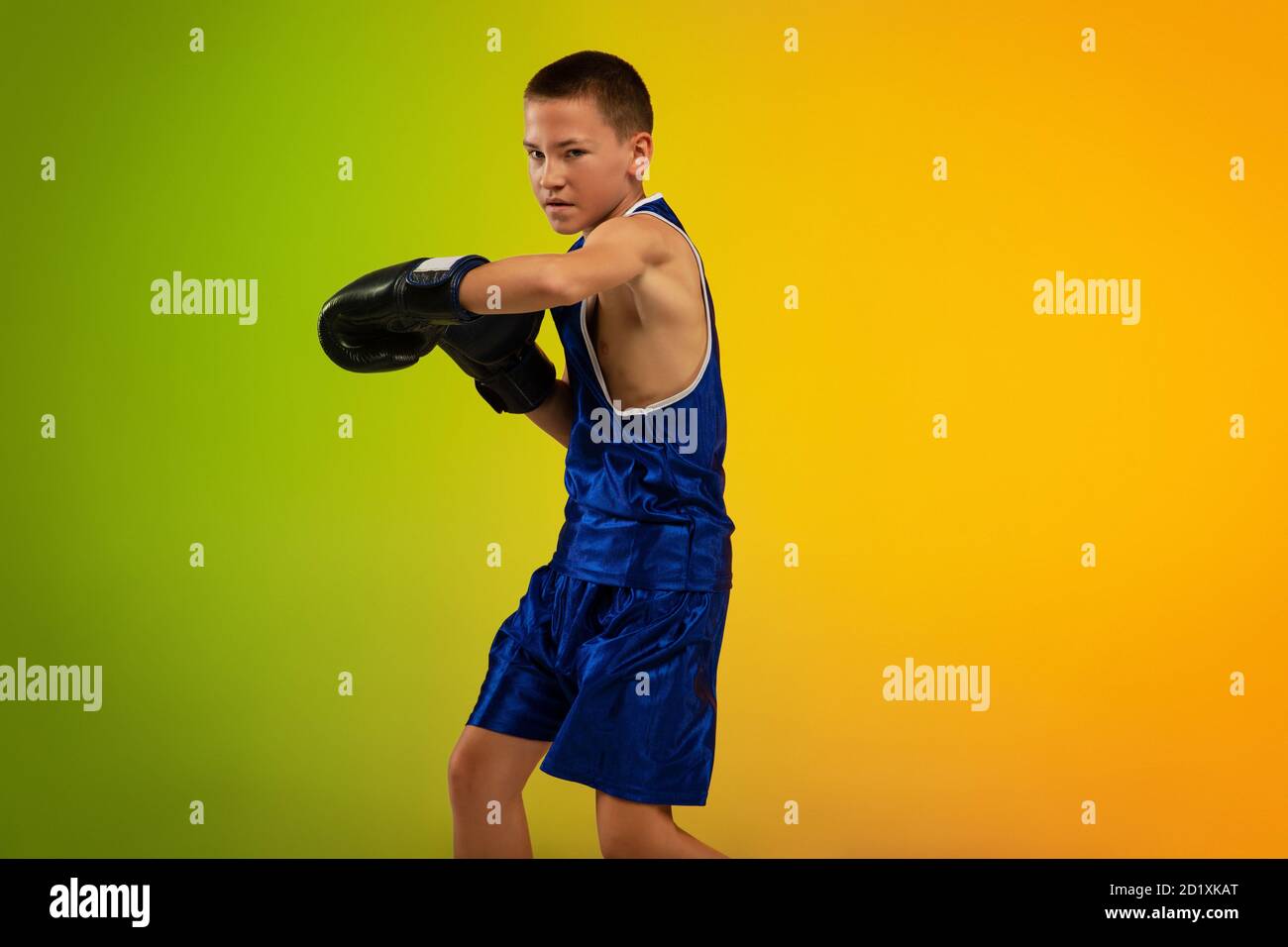 Force. Teenage professional boxer training in action, motion isolated ...