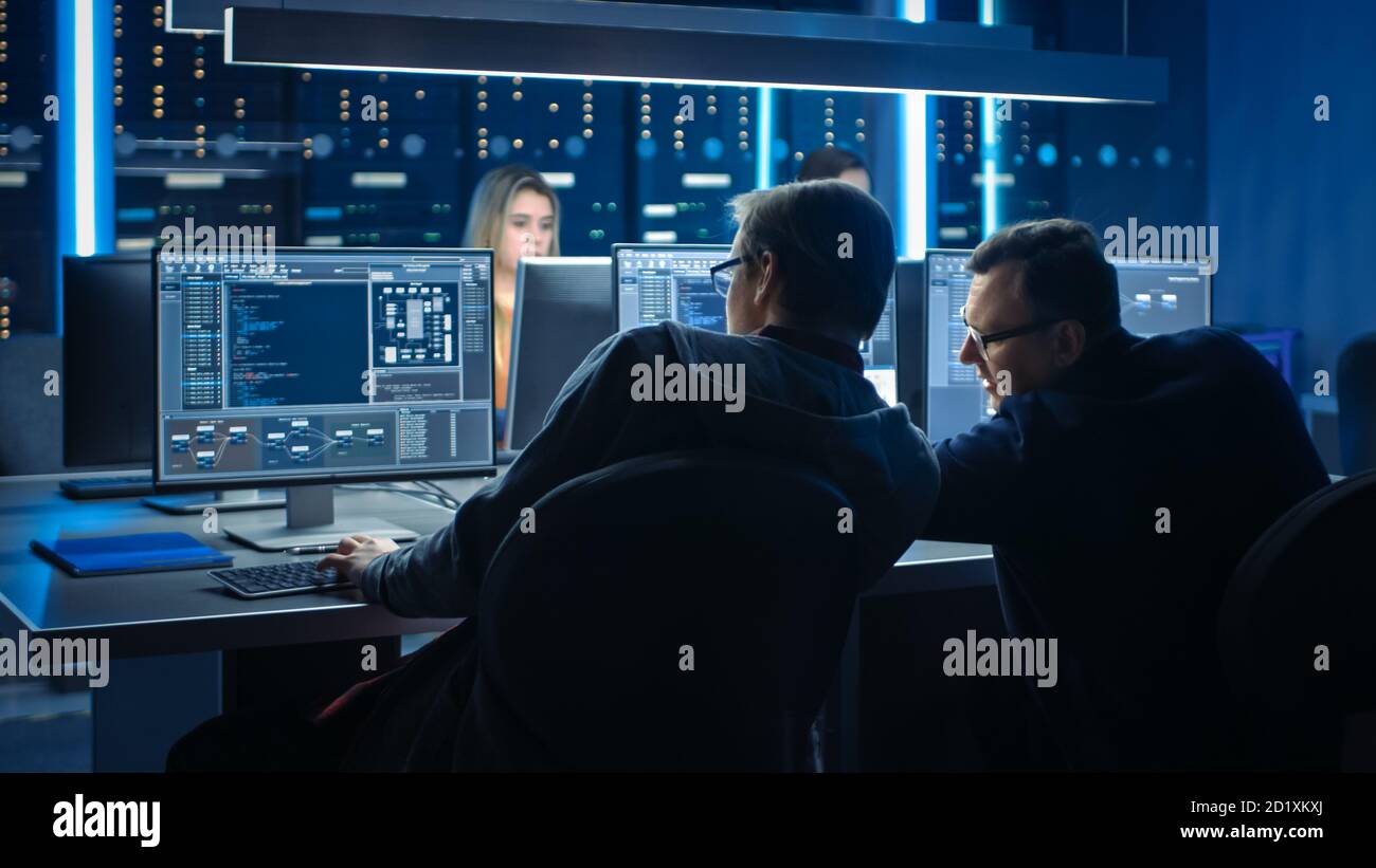 Team of IT Programers Working on Desktop Computers in Data Center ...