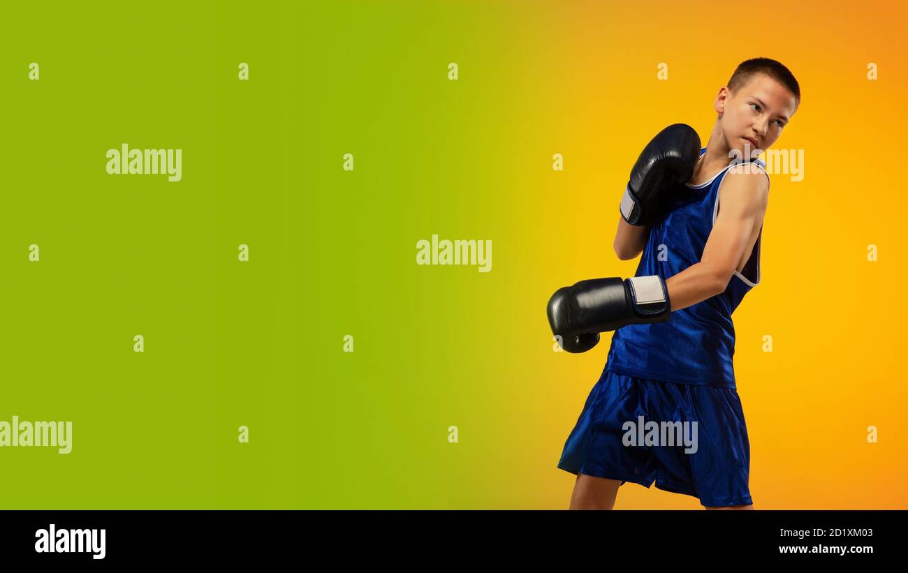Force. Teenage professional boxer training in action, motion isolated ...