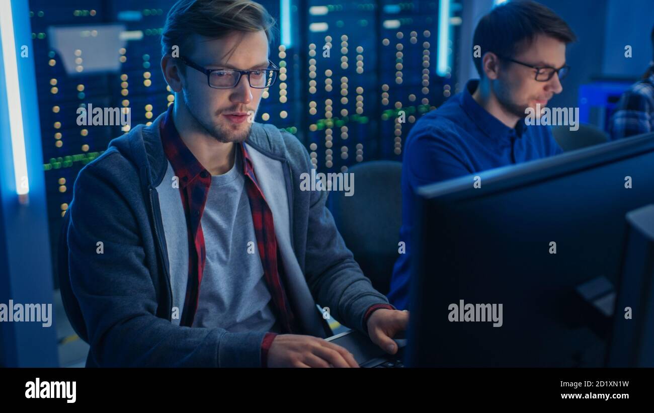 Team of Young IT Programers Working on Desktop Computers in Data Center ...