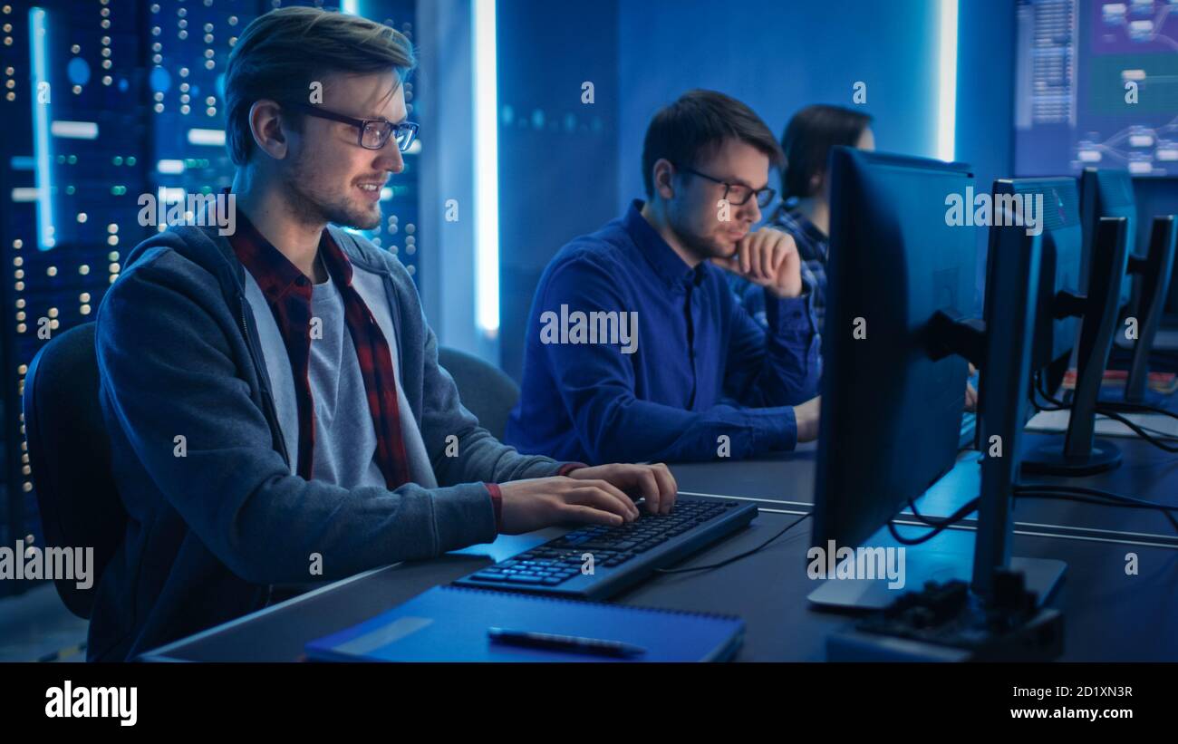 Team of Young IT Programers Working on Desktop Computers in Data Center ...