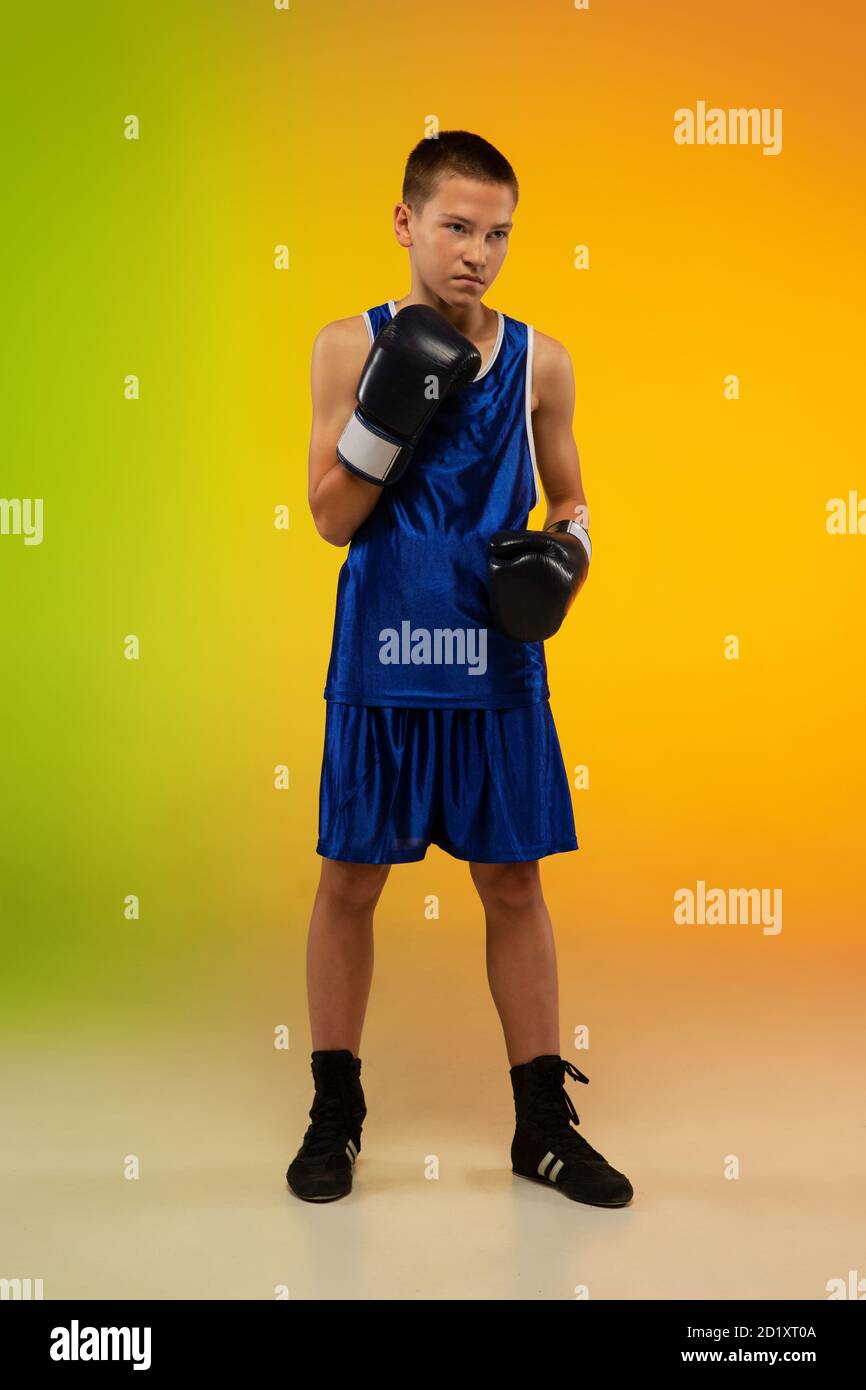 Fighter. Teenage professional boxer training in action, motion isolated ...