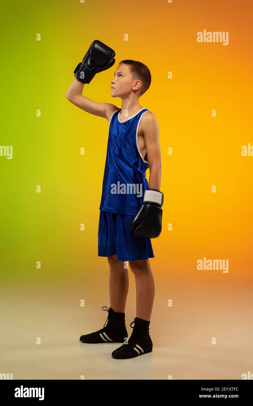 Fighter. Teenage professional boxer training in action, motion isolated ...