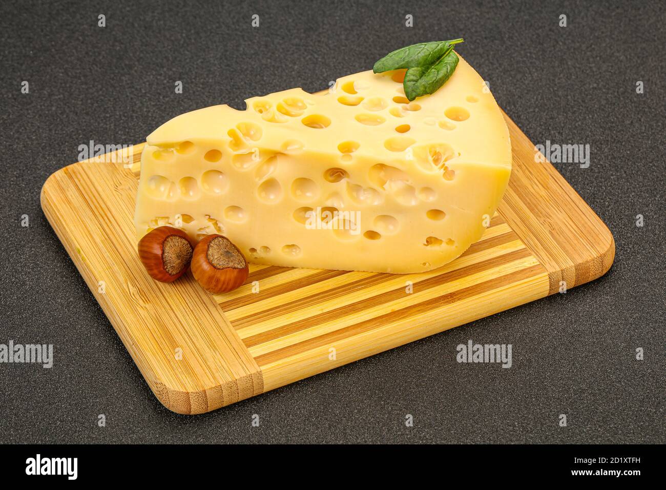 Maasdam cheese - dairy yellow triangle with holes Stock Photo - Alamy