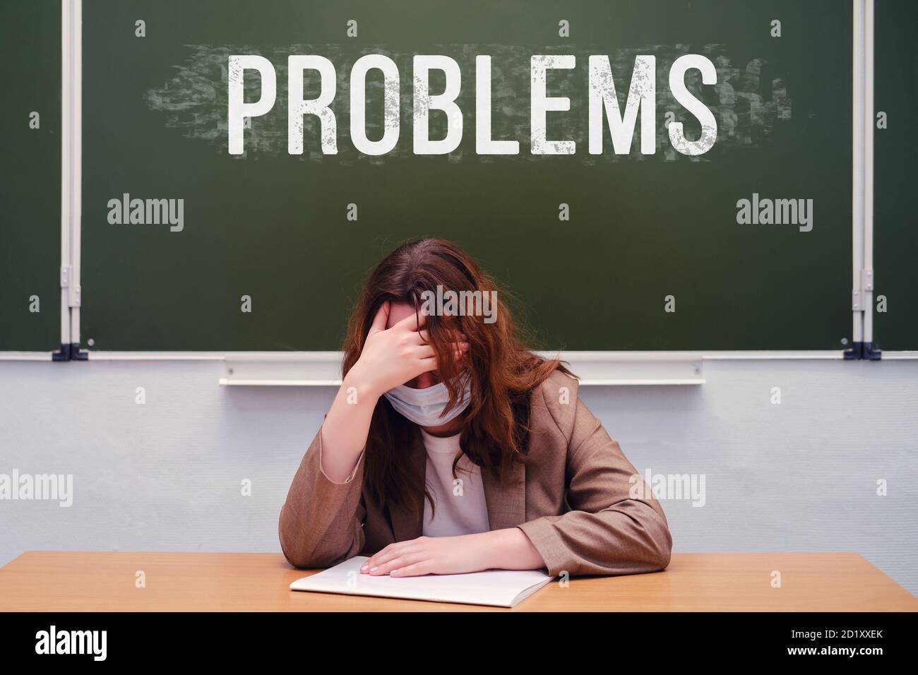 Sad teacher sits in a school class with the words "Problems Stock Photo ...