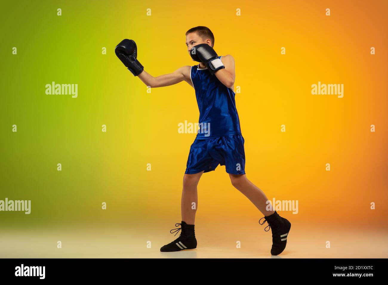 On the go. Teenage professional boxer training in action, motion ...