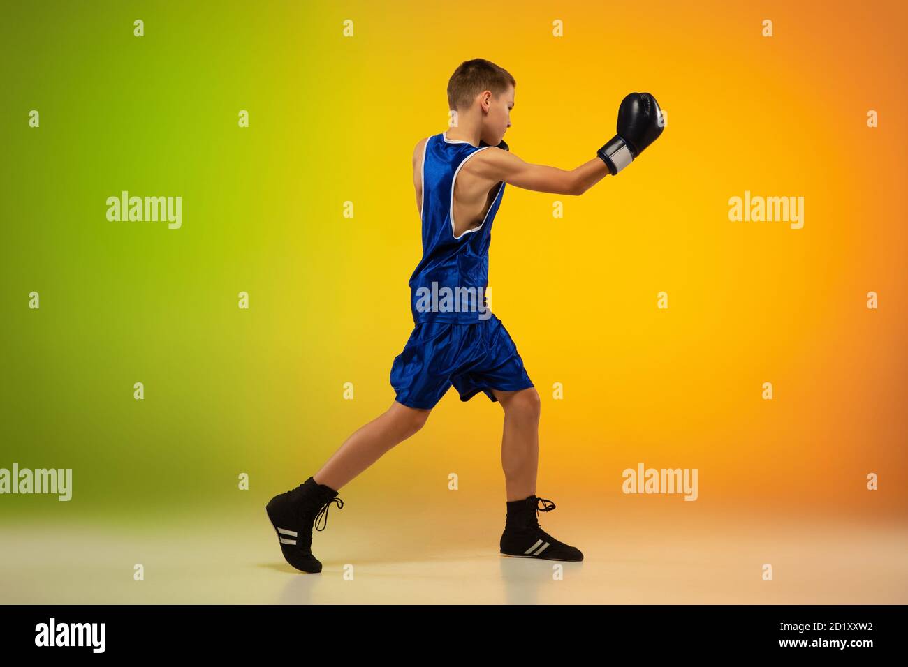 On the go. Teenage professional boxer training in action, motion ...