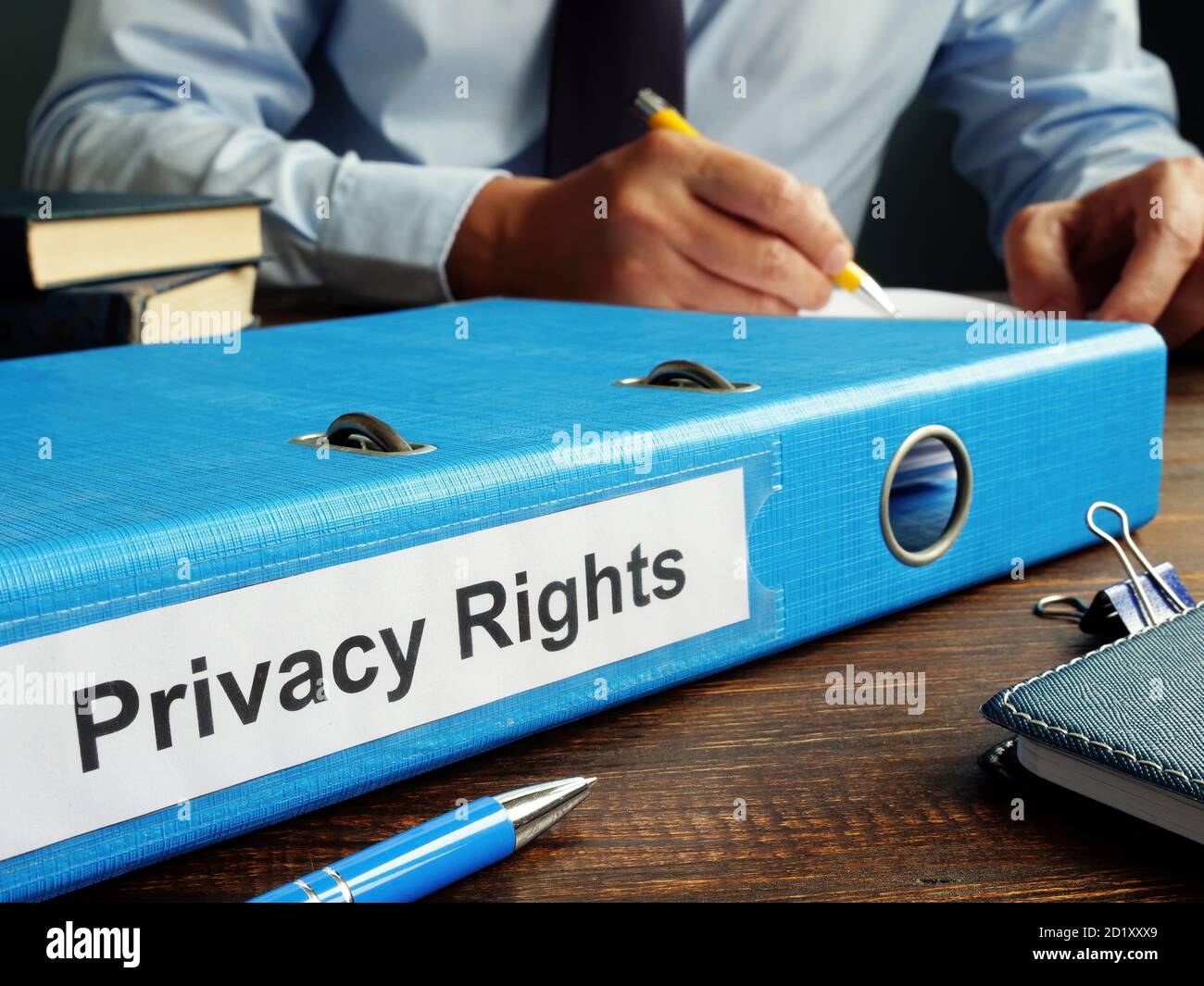 Folder labeled privacy rights. The lawyer makes notes in a notebook ...