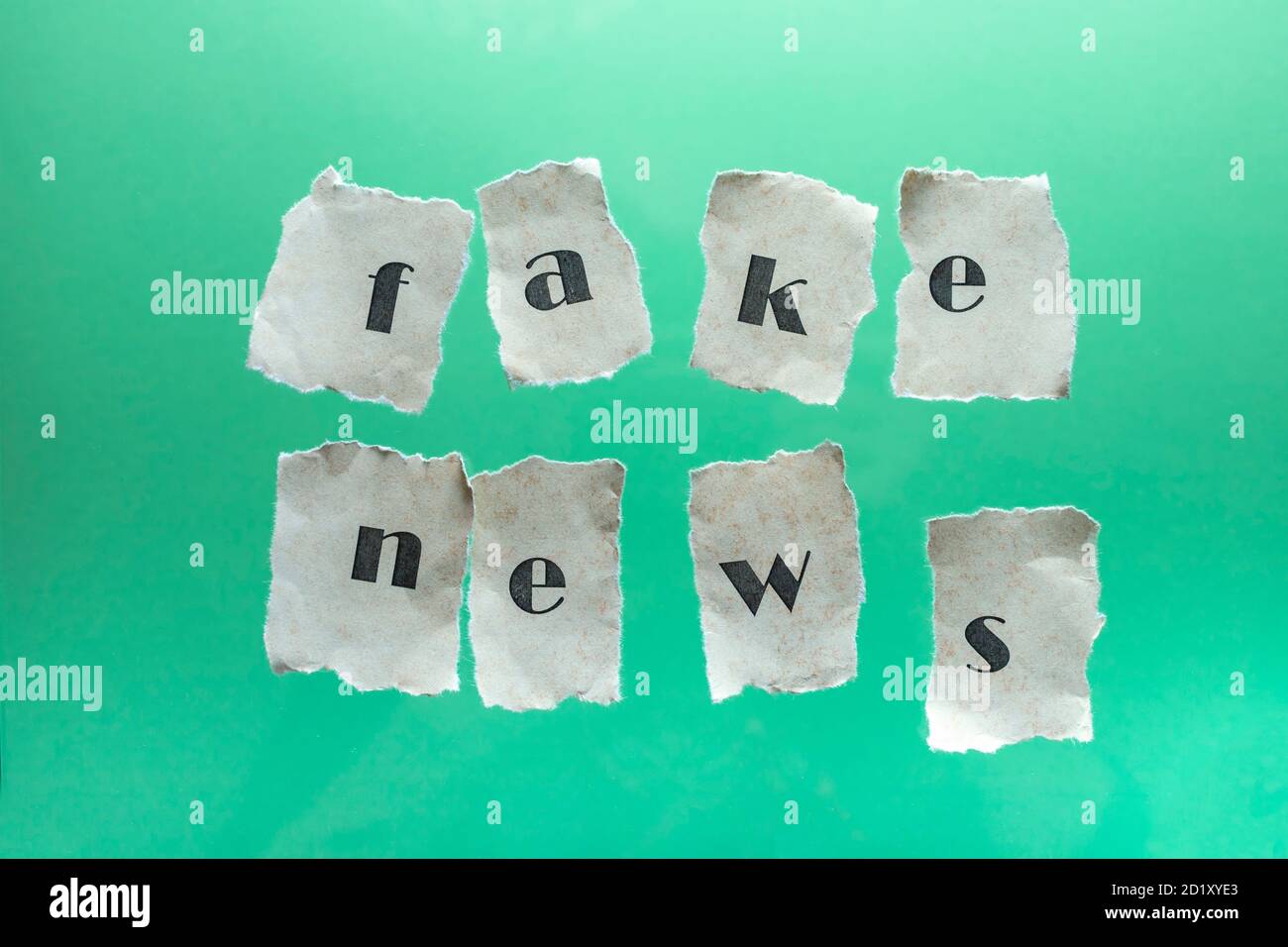 Fake news concept, letters written on old paper, on a green background ...