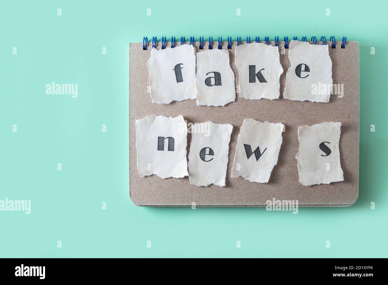 Fake news concept, letters written on old paper, on a green background ...