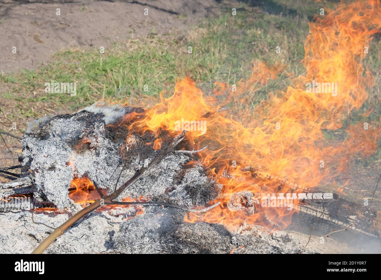 Big bonfire in the open air. A pile of ash from burnt boards and ...