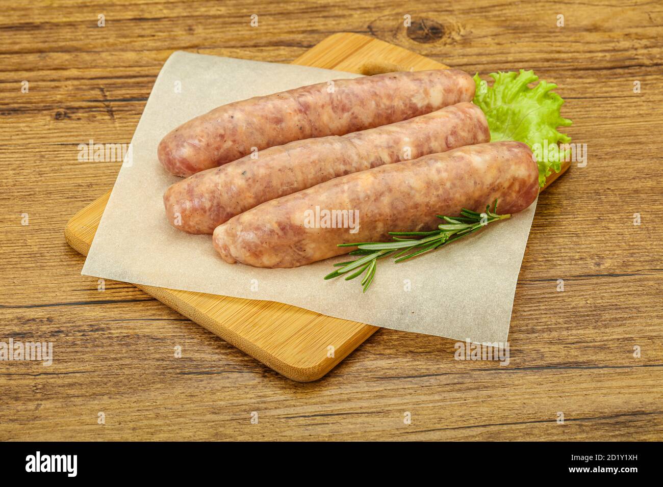 Raw pork meat sausages for grill served rosemary Stock Photo - Alamy