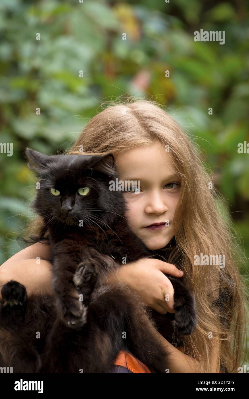 Beautiful little girl with long light hairs wearing a witch costume ...