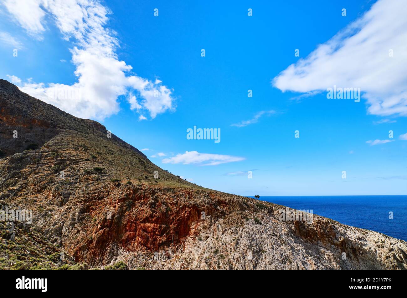 Beautiful wild red cliffs, clear blue sky, clouds. Diagonal view ...