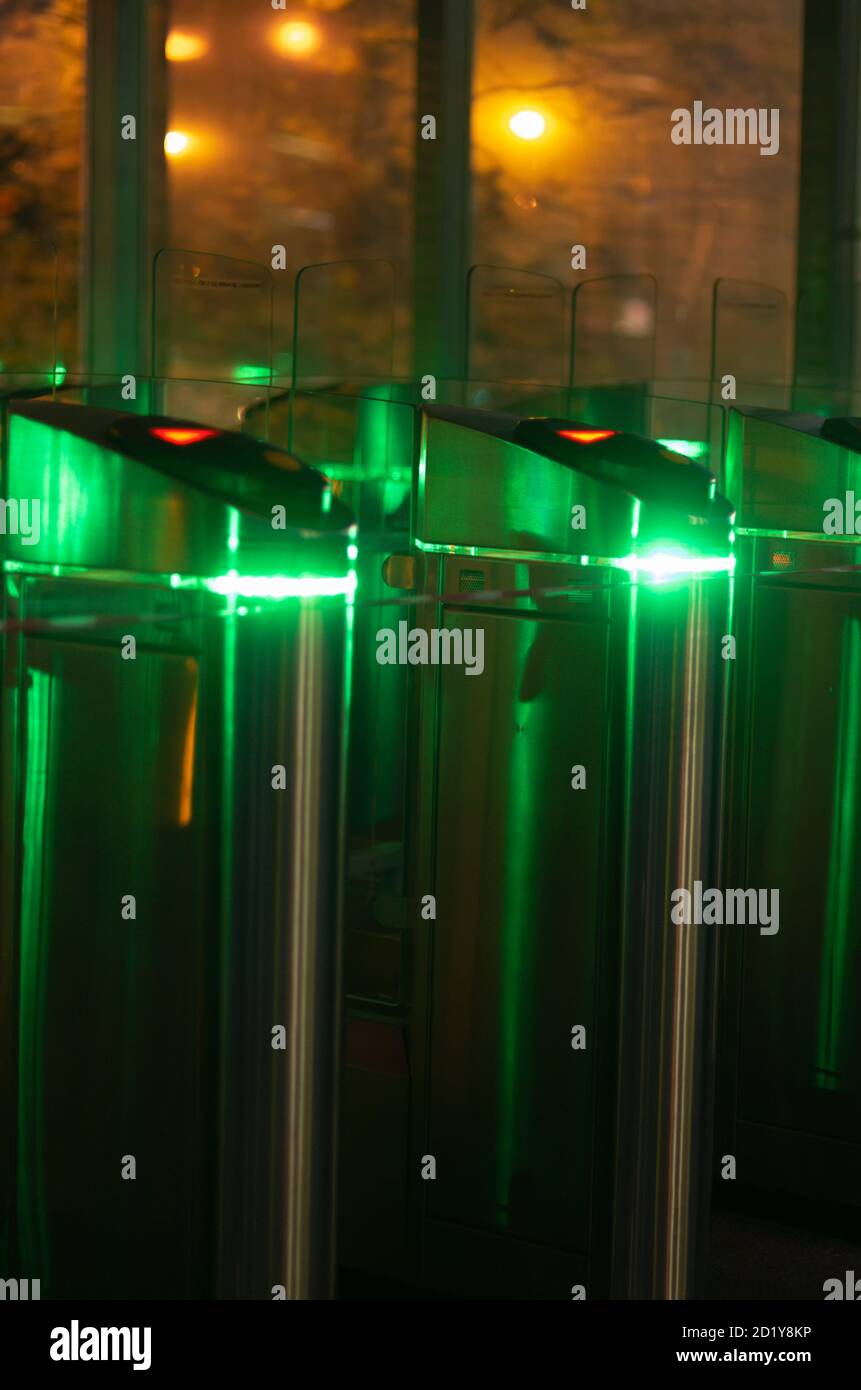 Night scene with two turnstiles with green led lighting without people ...